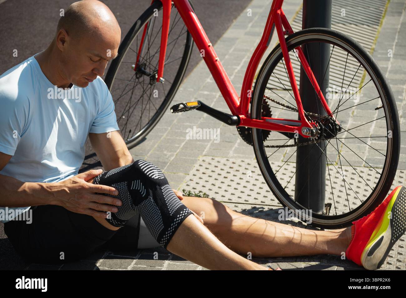 Cyclist fell off his bike and injured his knee. Unhappy cyclist with ...