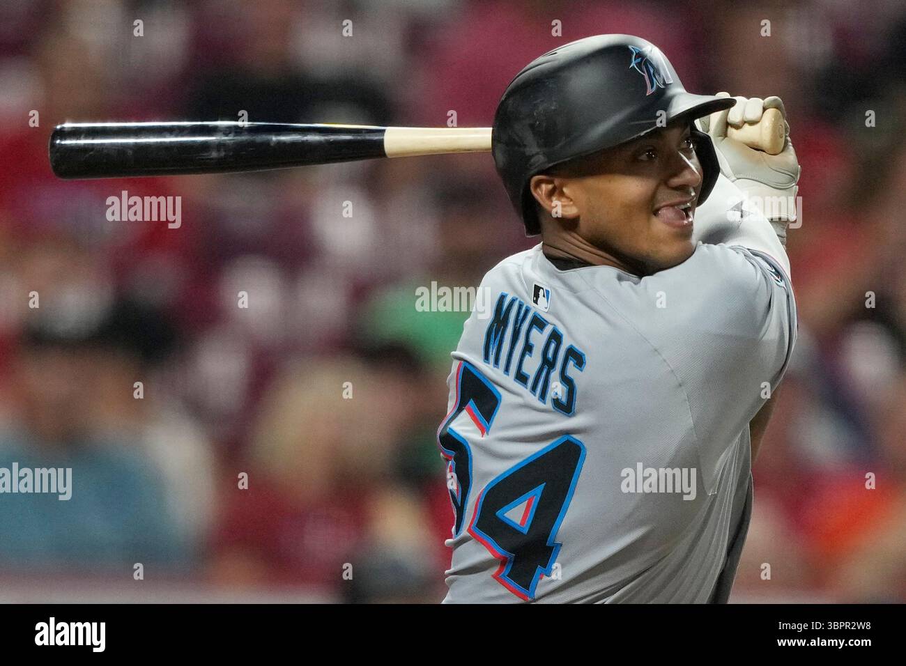 Miami Marlins' Dane Myers watches his sacrifice fly to score Connor ...
