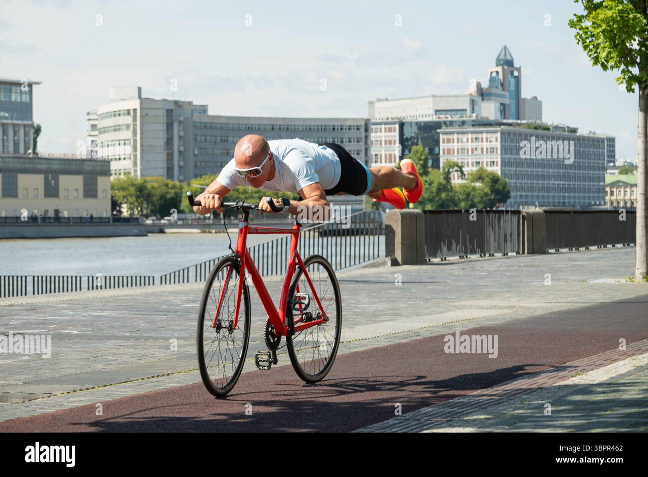 Happy cyclist rides bicycle at urban public park. Man riding bicycle ...