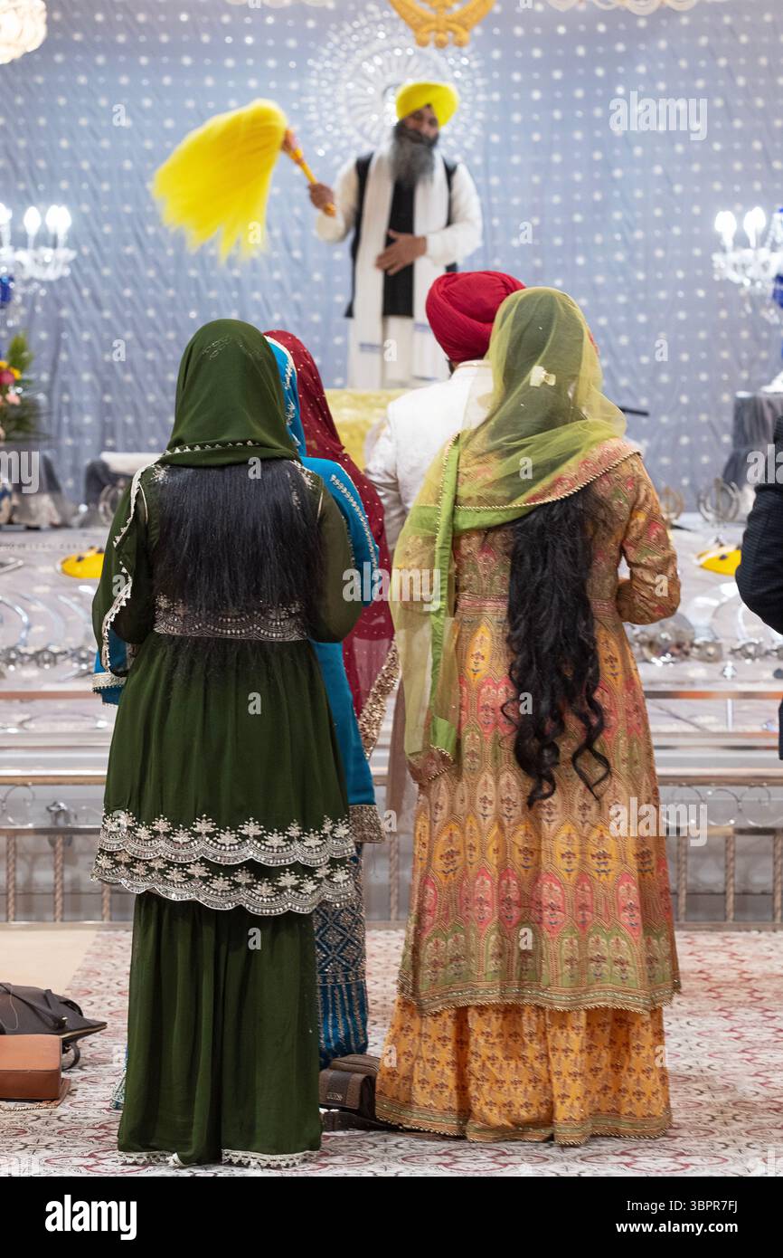 An unusual view of a Sikh wedding barely showing the bride and groom ...