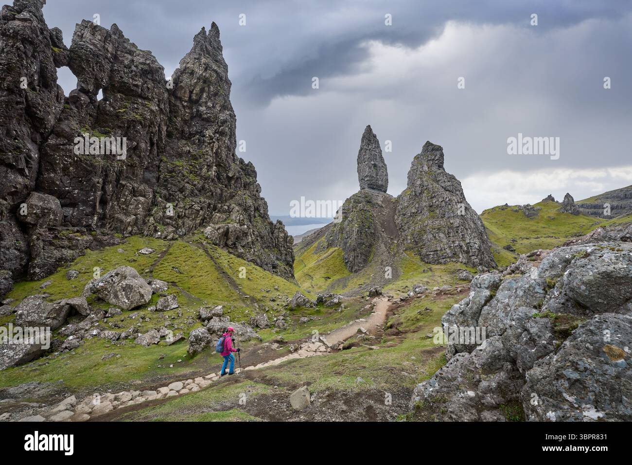 active senior woman hiking below the spectacular pinnacles of Old Man ...