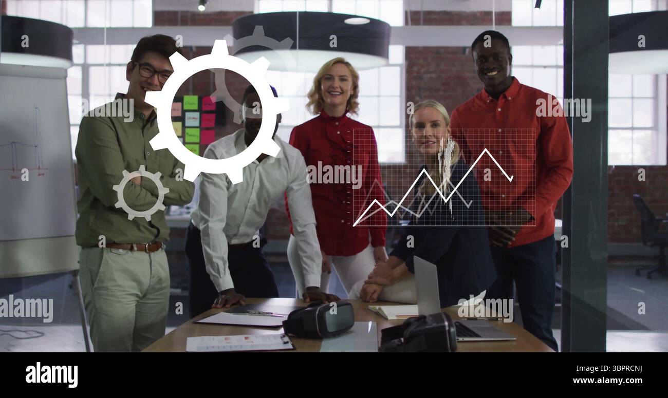 Collaborating team of five discussing plan around table in office, with ...