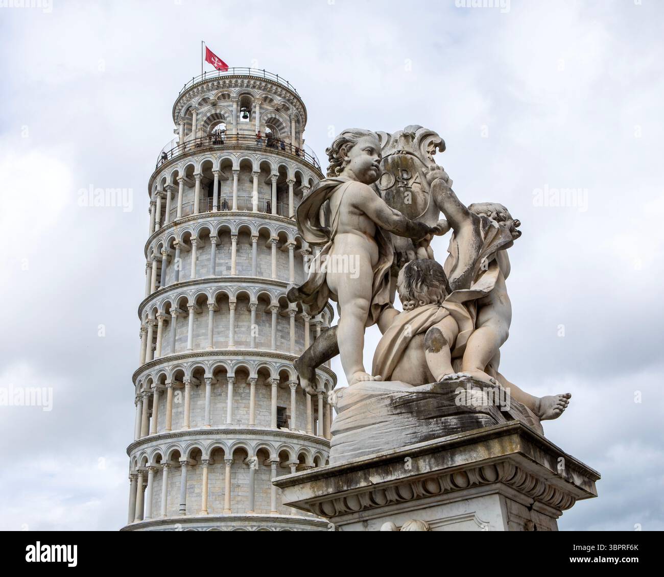 Pisa, Italy - April 15th 2025: Statue of Cherubs with the Leaning Tower ...