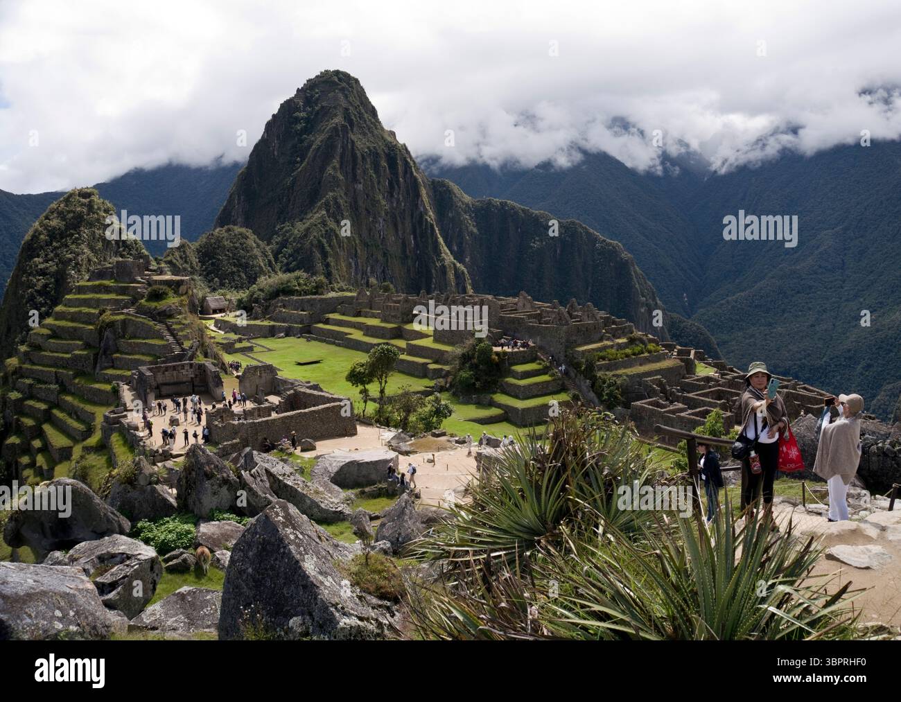 Tourists make photographs at Machu Picchu, the 15th-century Inca ...