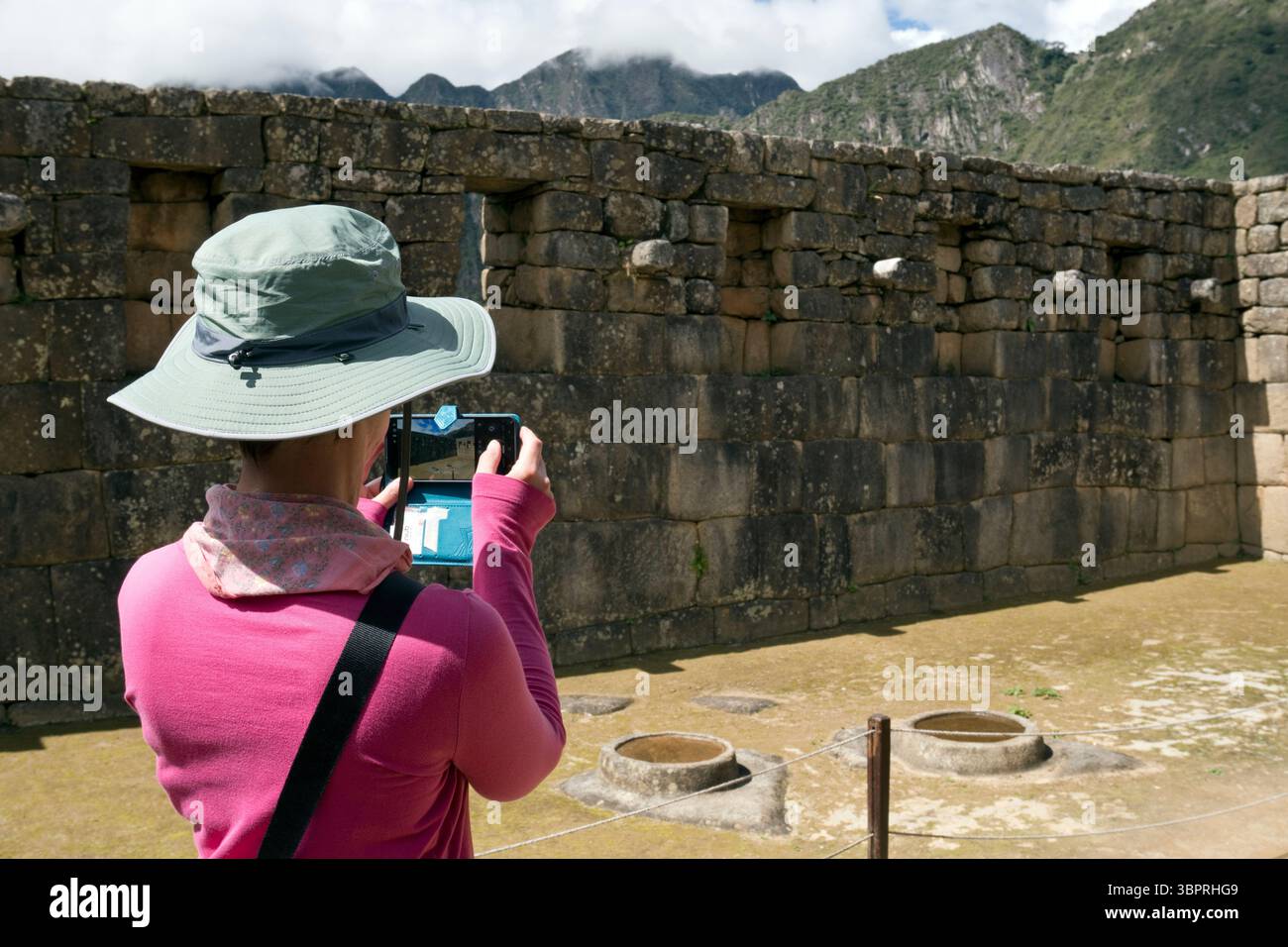 A tourist photographs "water mirrors" at Machu Picchu, the 15th-century ...