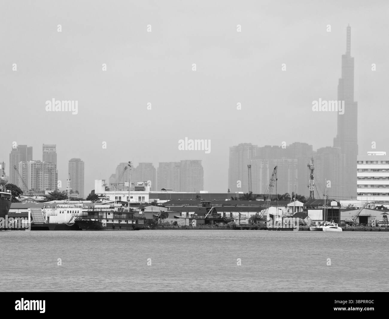 Saigon river with port infrastructure and Landmark 81 skyscraper in the ...