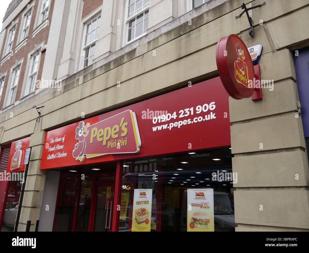 Pepe’s, piri piri Corporate logo signs in York City centre in June 2025 ...