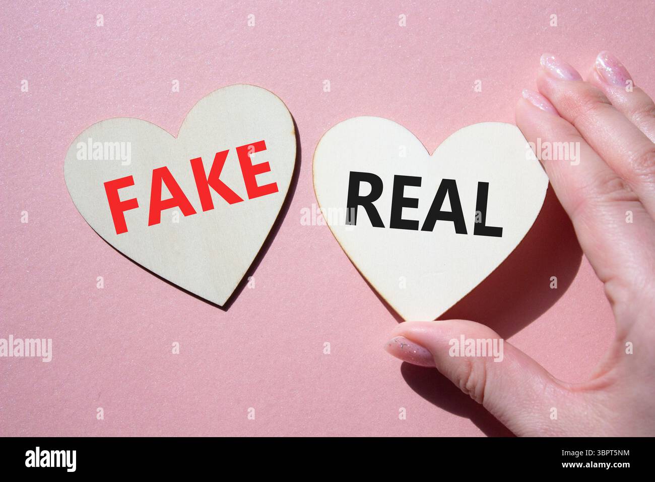 Real or Fake symbol. Concept word Real or Fake on wooden hearts ...