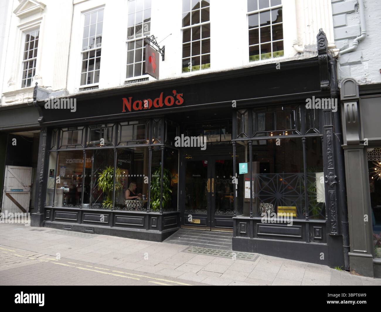 Nando’s, chicken Corporate logo signs in York City centre in June 2025 ...