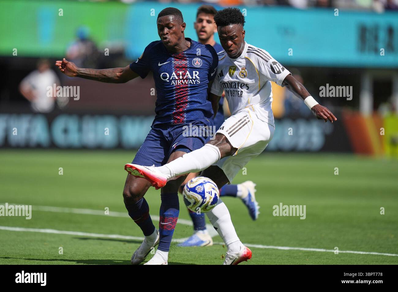 Real Madrid's Vinicius Junior, right, is blocked by Paris Saint-Germain's Nuno Mendes (25 ...