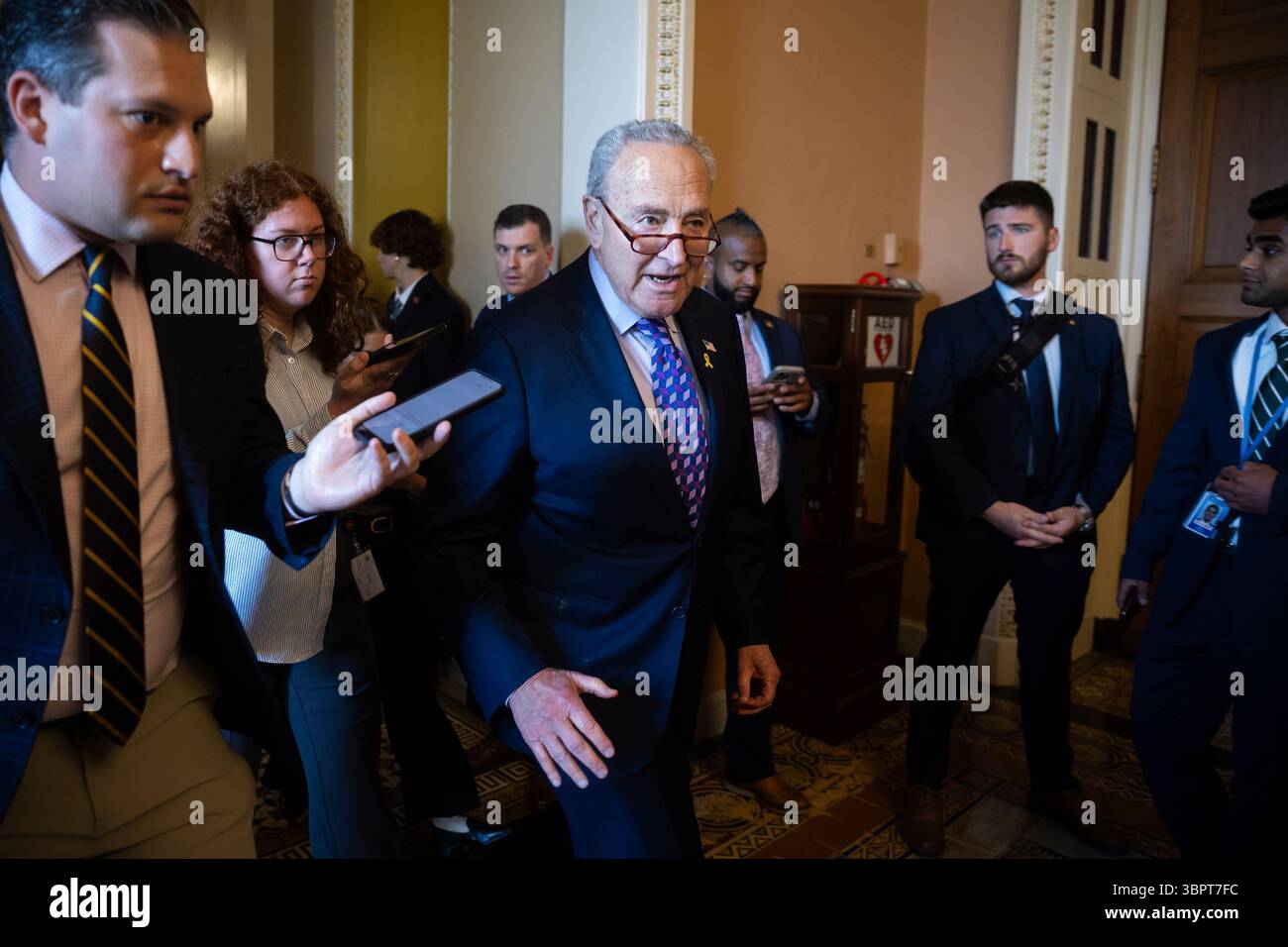 Senate Minority Leader Chuck Schumer (D-N.Y.) speaks with a reporter as ...
