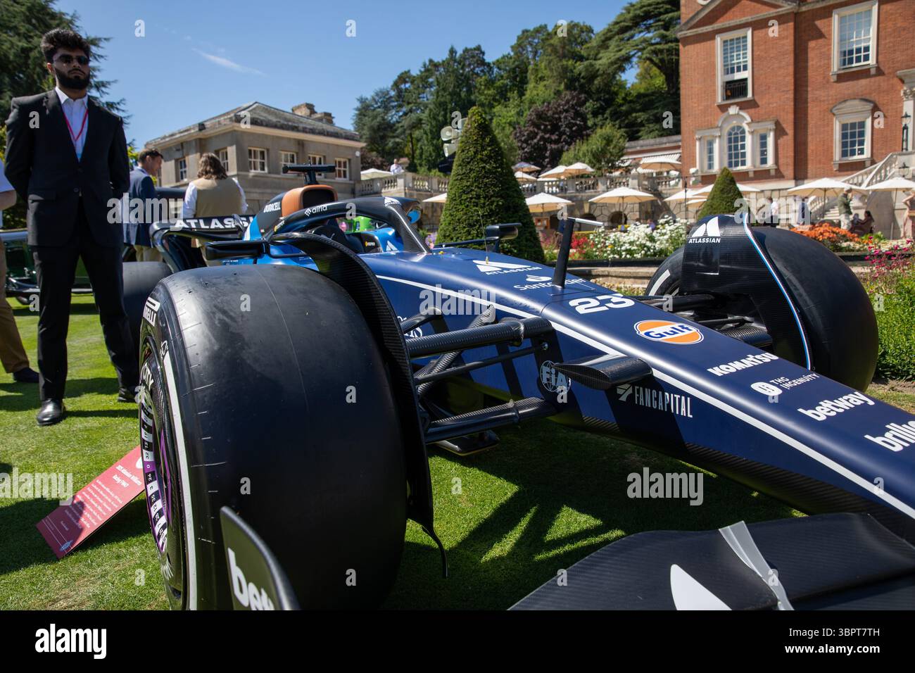 A security guard watches over a replica Williams 2025 F1 race car. The ...