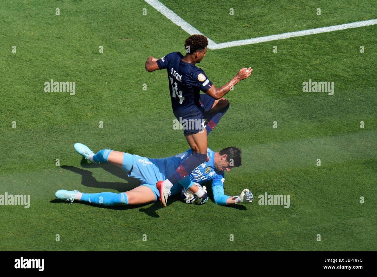 Paris Saint-Germain's Desire Doue (14) leaps over Real Madrid's Thibaut ...