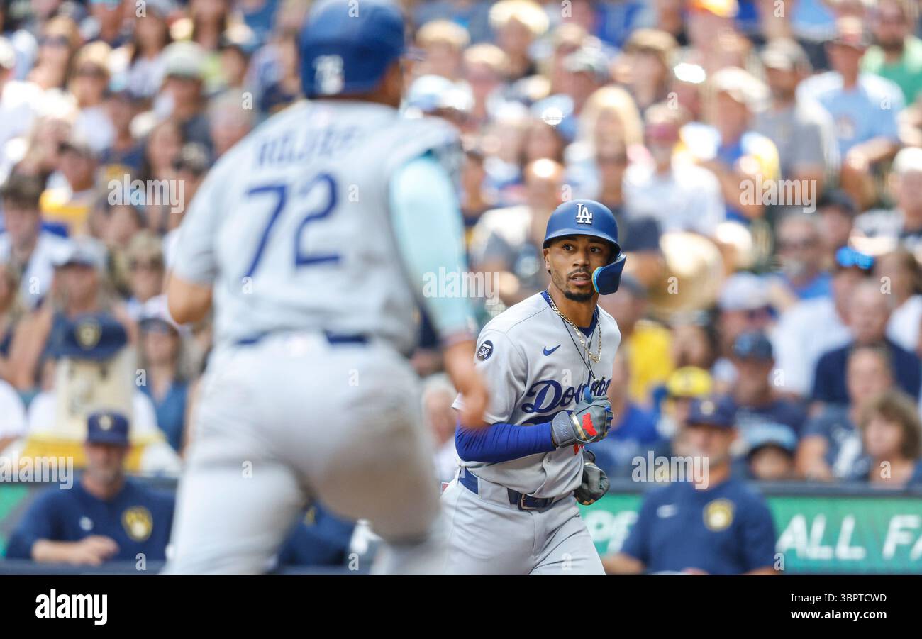 Los Angeles Dodgers' Mookie Betts, right, watches after he hit a run ...