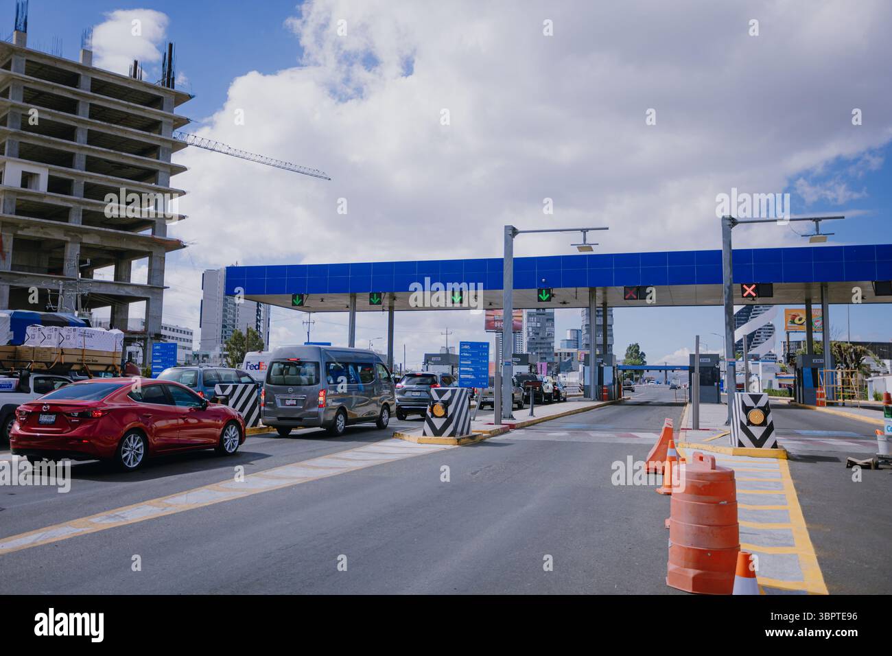 Cars line up at the Atlixcáyotl toll booth in Puebla, Mexico, showing ...