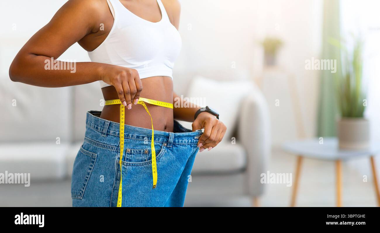Happy Black Lady Showing Large Jeans Measuring Thin Waist Indoors Stock ...