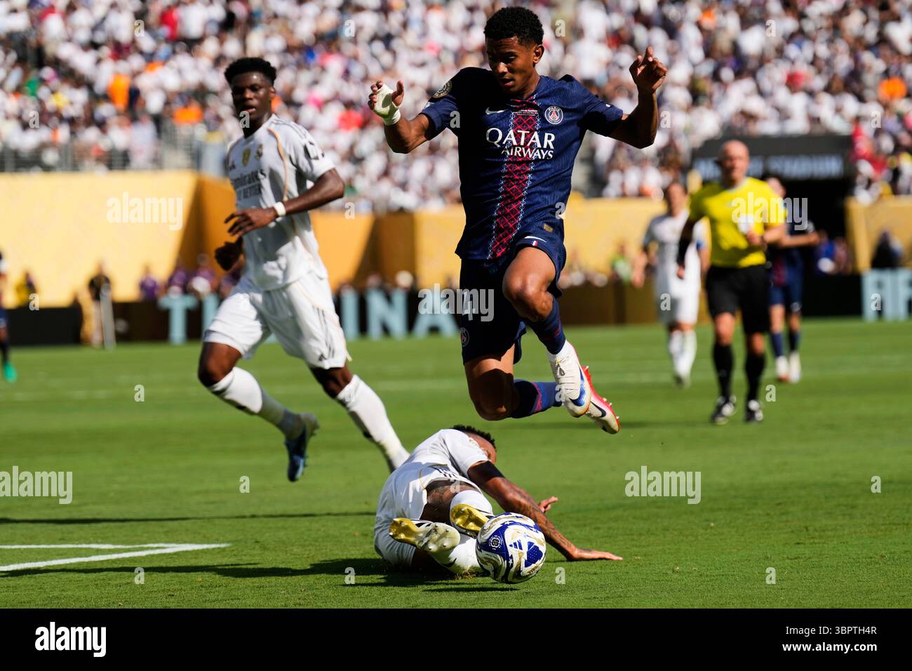 Paris Saint-Germain's Senny Mayulu (24) leaps over Real Madrid's Eder Militao (3) during the ...