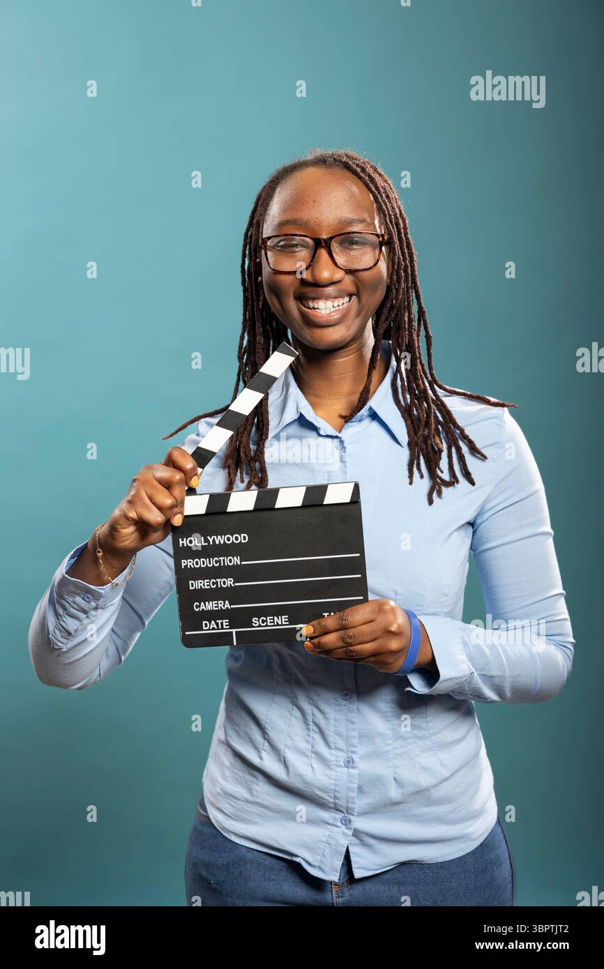 Portrait of african american female movie director happily holding ...
