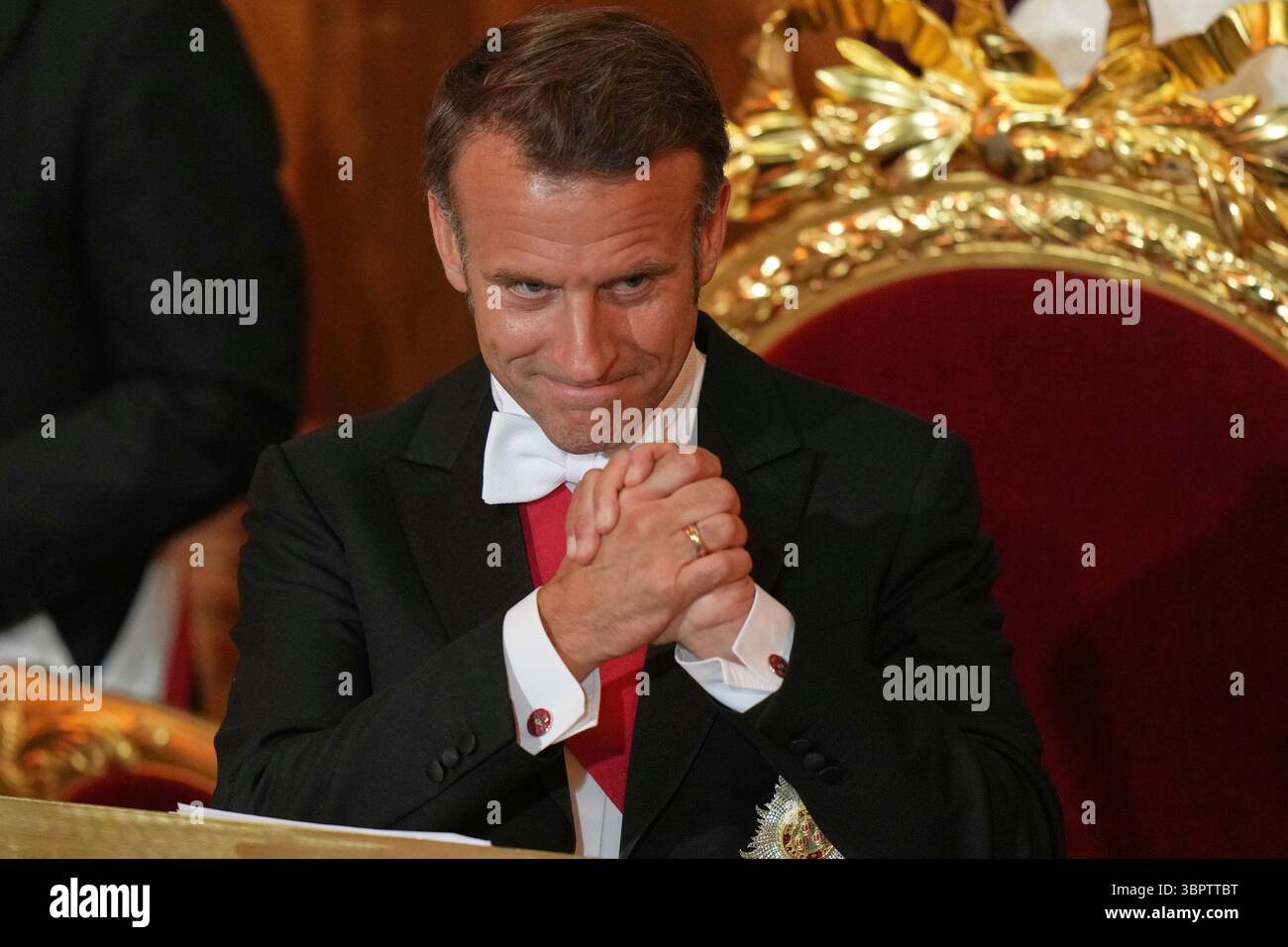 French President Emmanuel Macron gestures as he receives applause after ...
