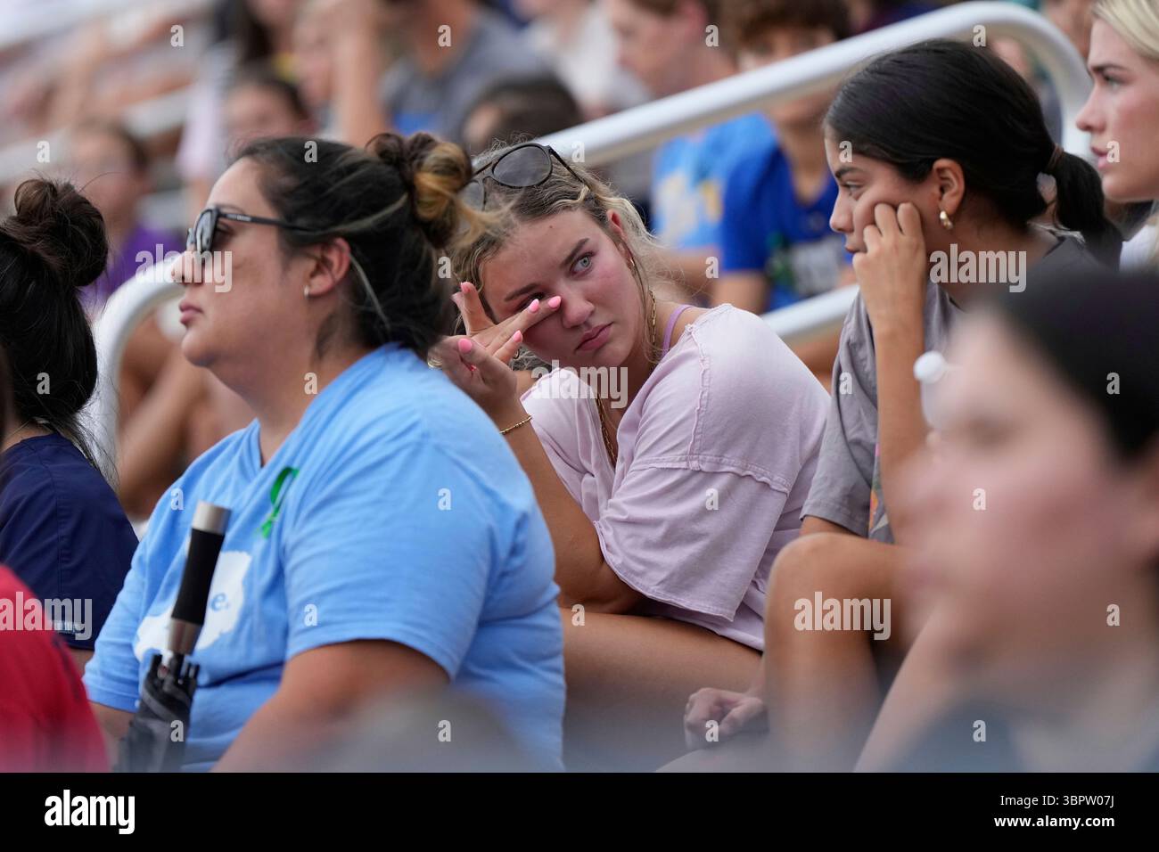 People attend a vigil for flooding victims at Tivy Antler Stadium on ...