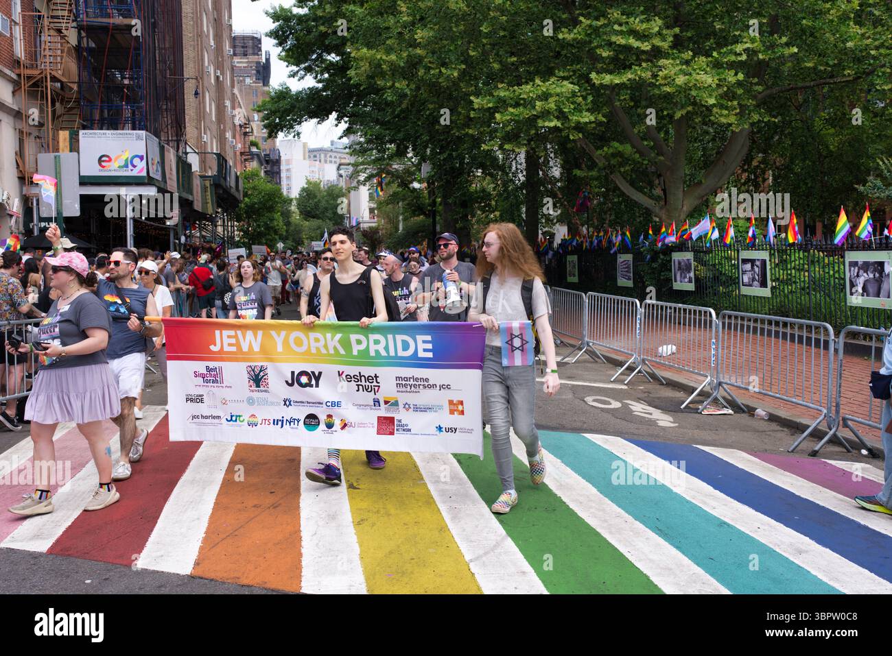 A group of people march in a New York City Pride parade, carrying a ...