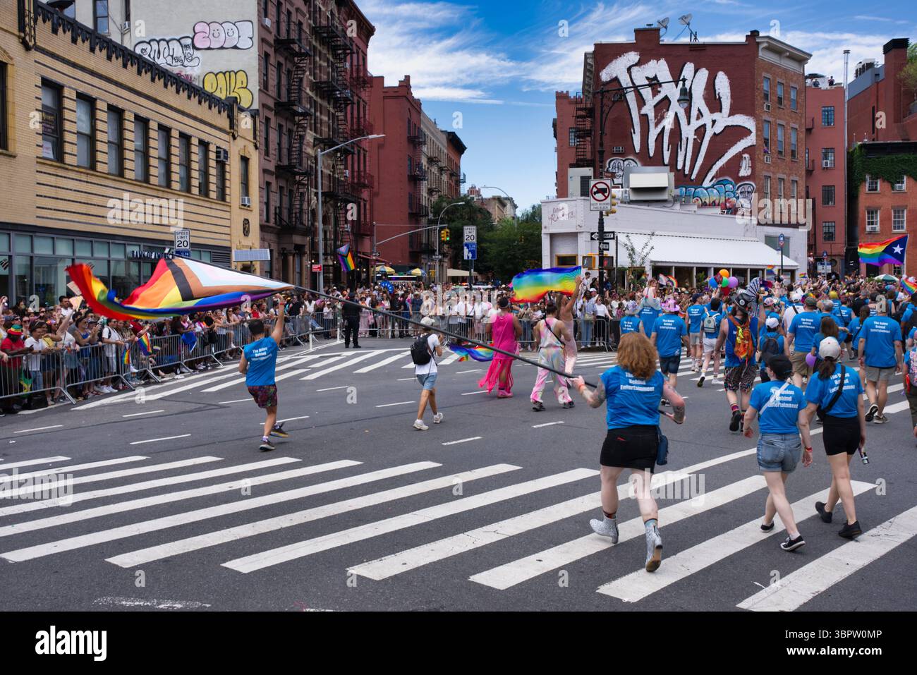 A vibrant Pride parade scene unfolds on a city street, featuring ...
