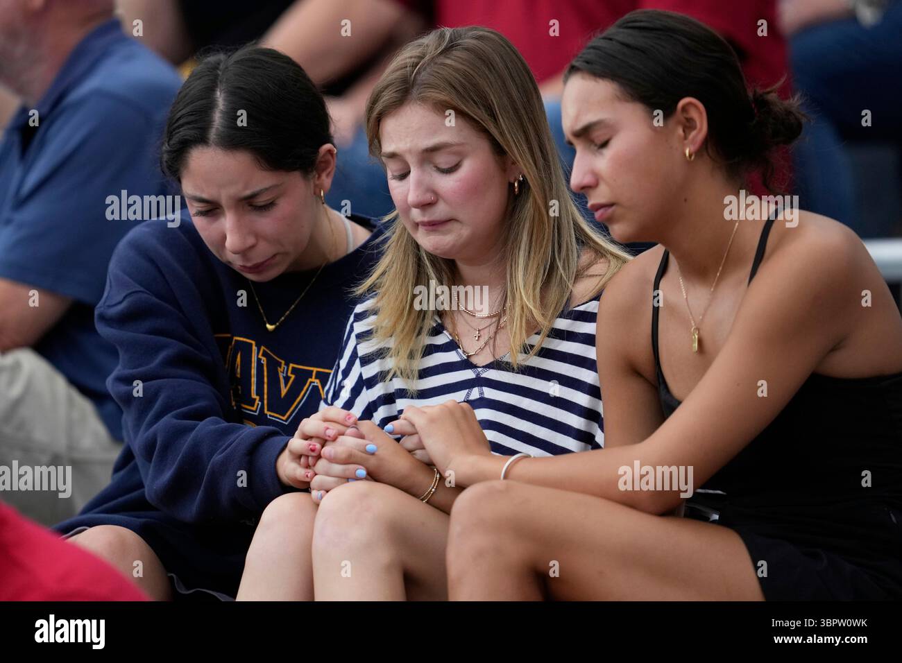Attendees react during a vigil for flooding victims at Tivy Antler ...