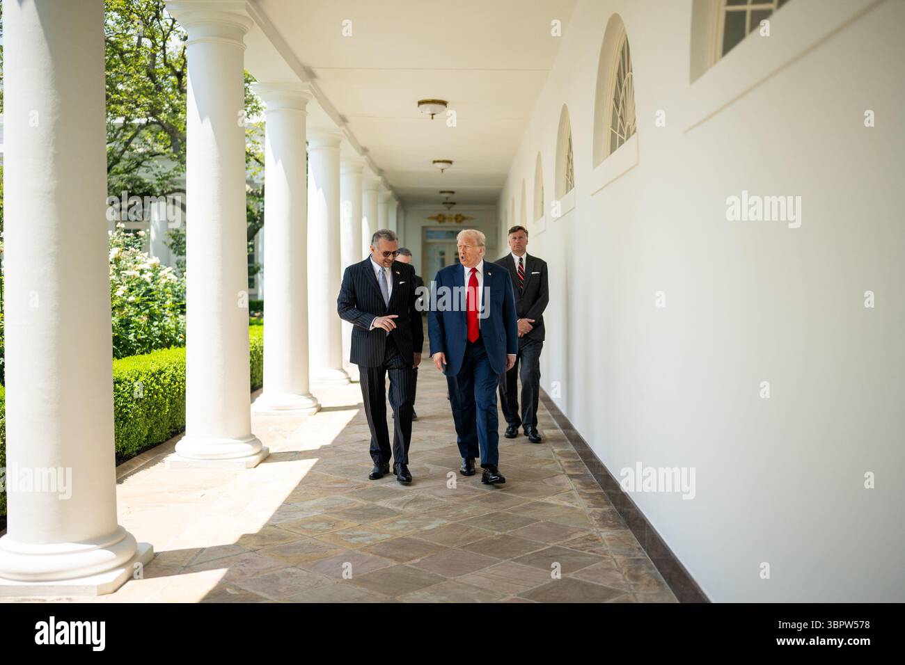 President Donald Trump walks with Massad Boulos on the West Colonnade ...
