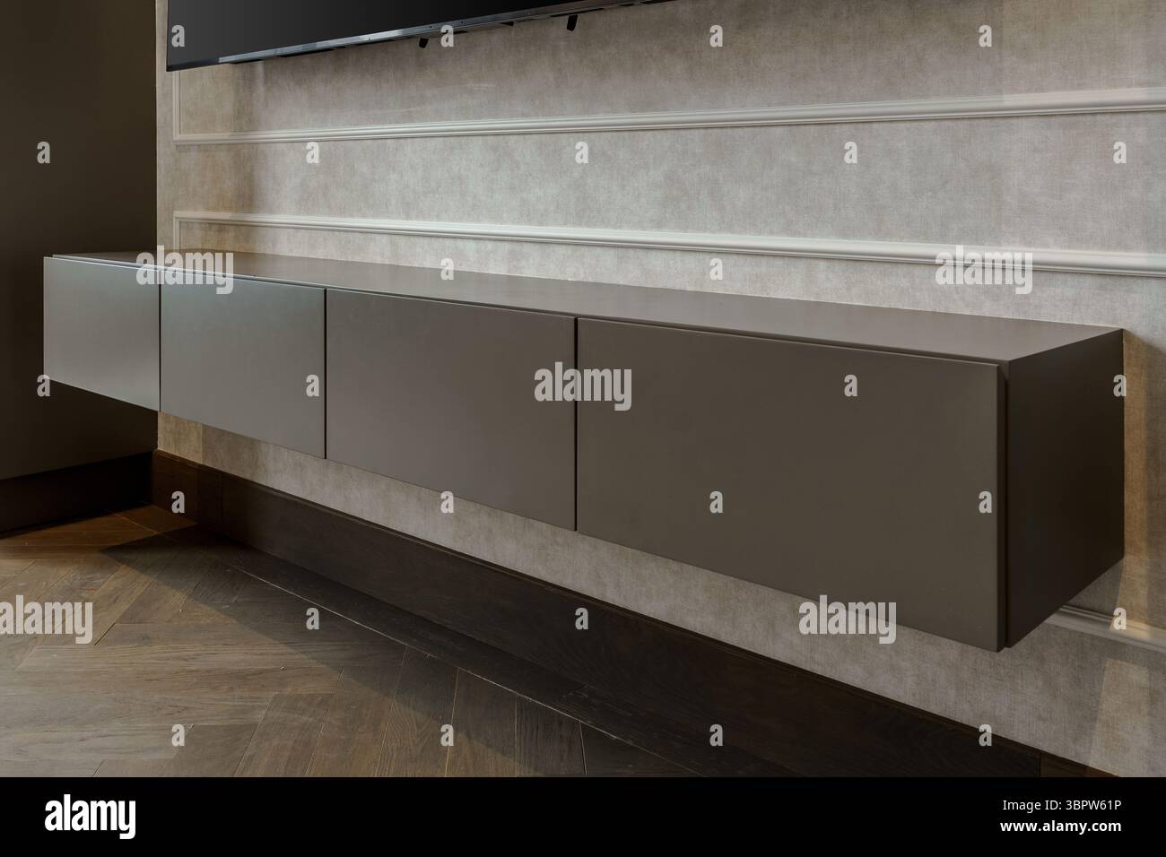 Modern minimalist floating TV console in a gray finish, mounted on a ...