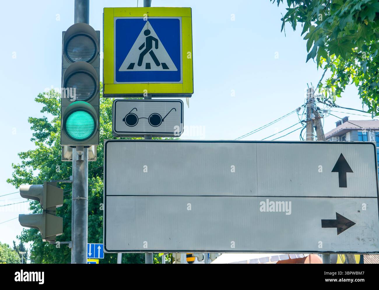 Traffic lights and direction signs against blue sky. Direction and ...