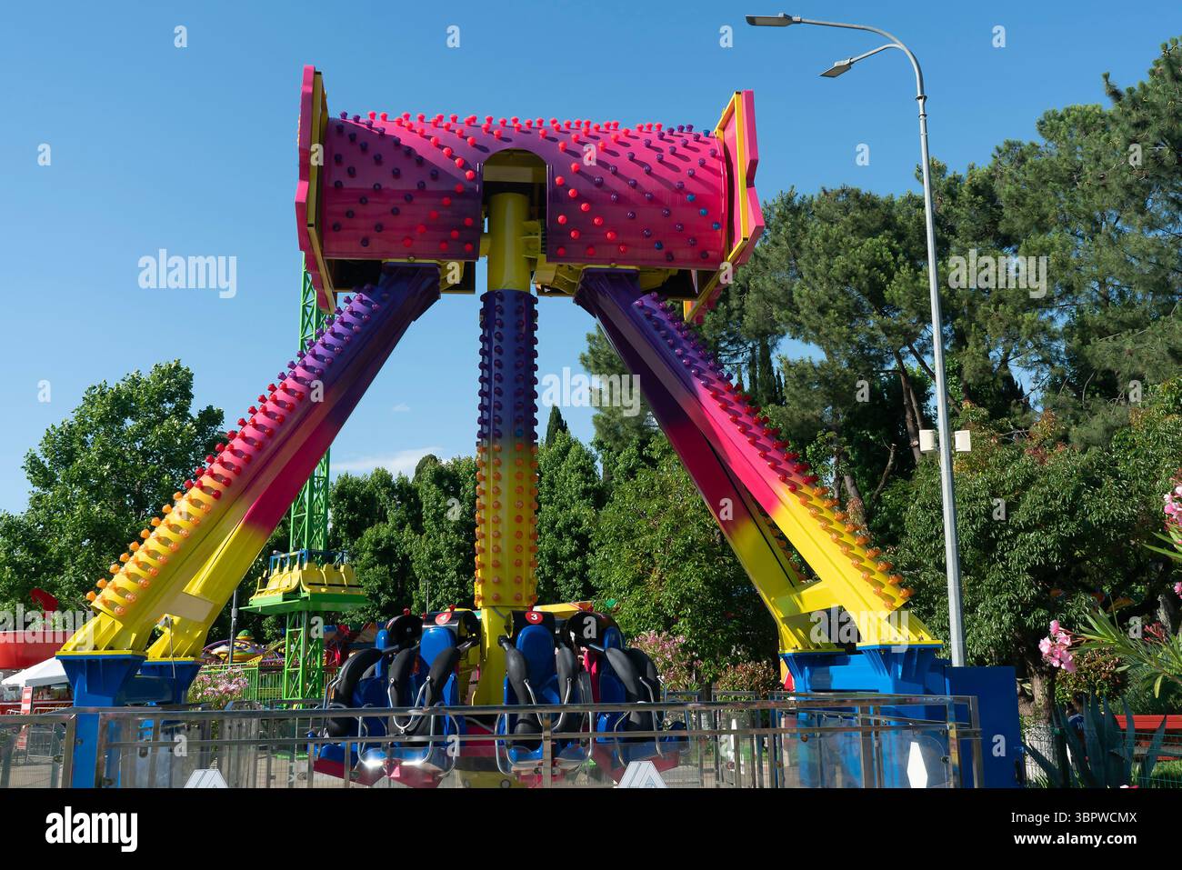 Bright colorful carousel in a summer amusement park. Childrens carousel ...