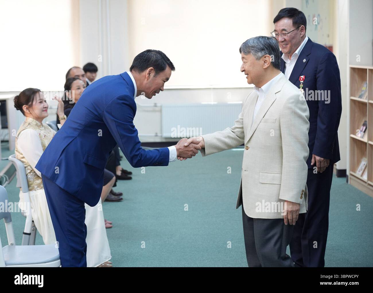 Japan's Emperor Naruhito talks with teachers and others at the Shine ...