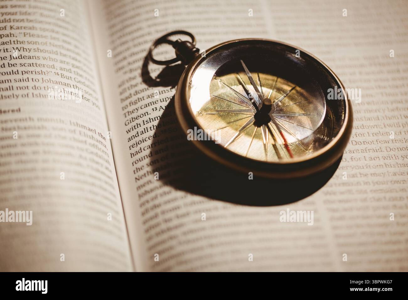Old fashioned watch on open book Stock Photo - Alamy