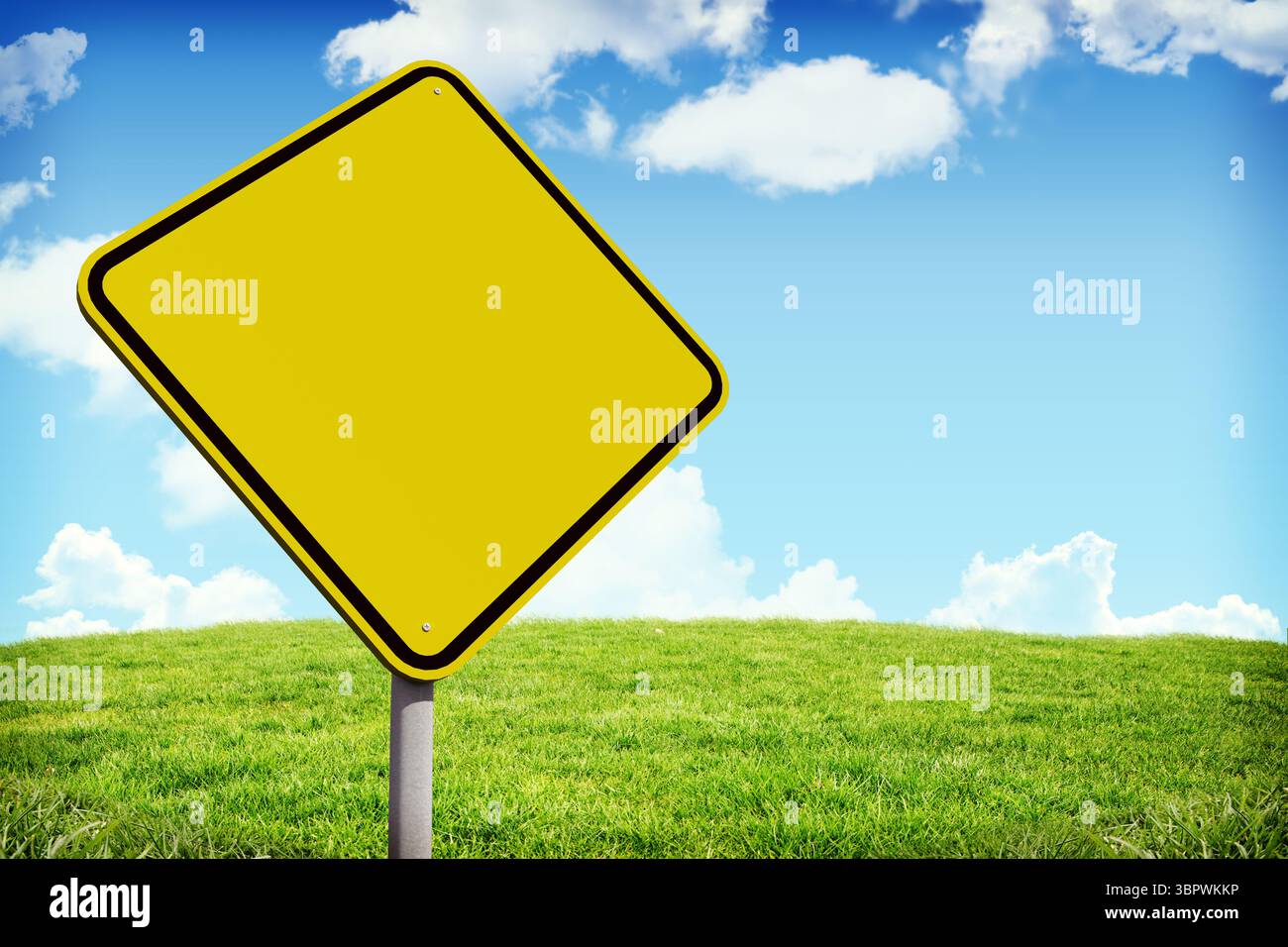 Yellow road sign by grass Stock Photo - Alamy