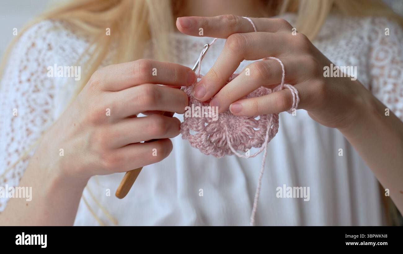 Women's hands crocheting an openwork product. Timeless craft of crochet ...