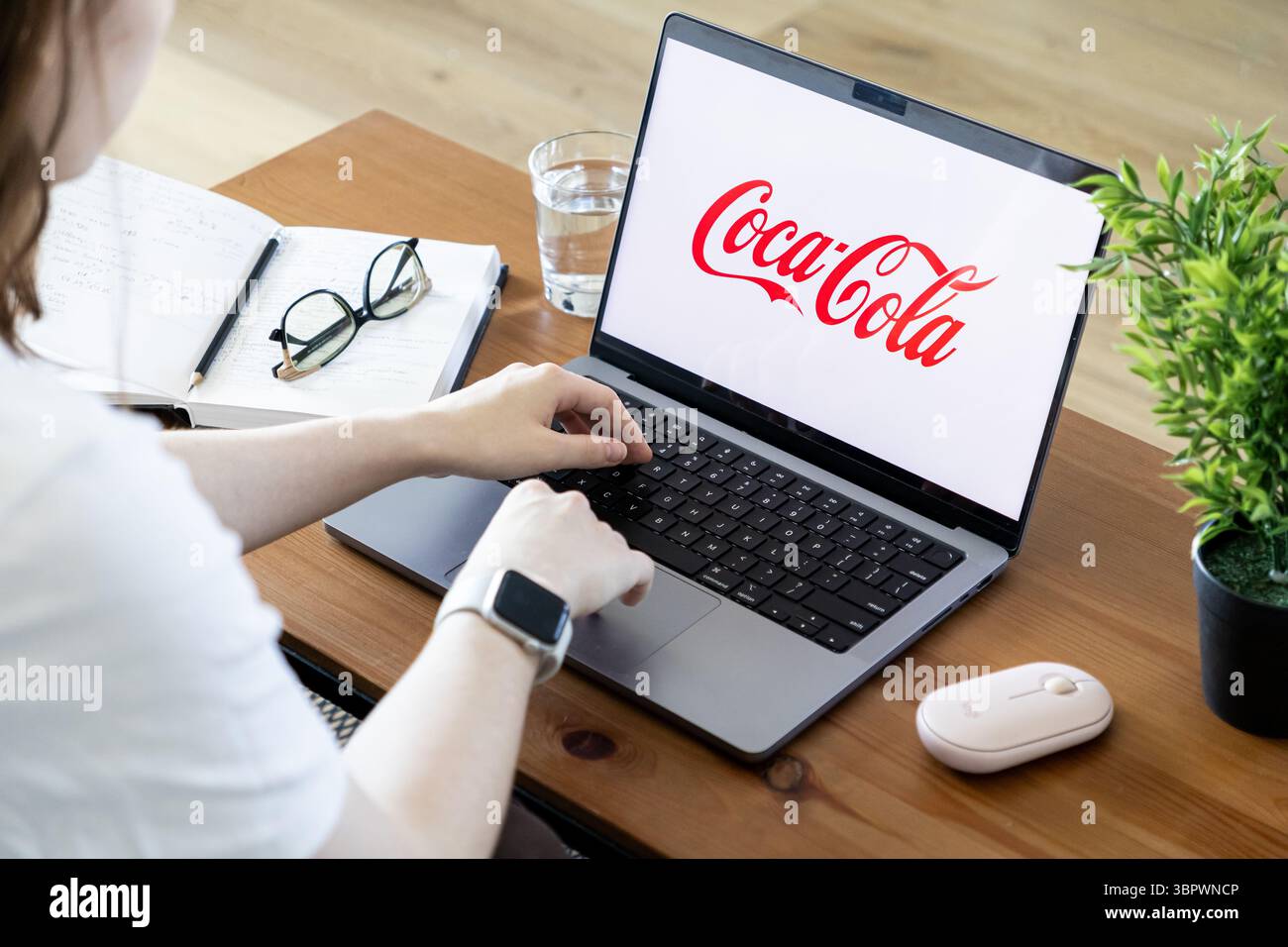 Poznan, Poland - June 15, 2025: A person typing on a sleek laptop computer, prominently ...