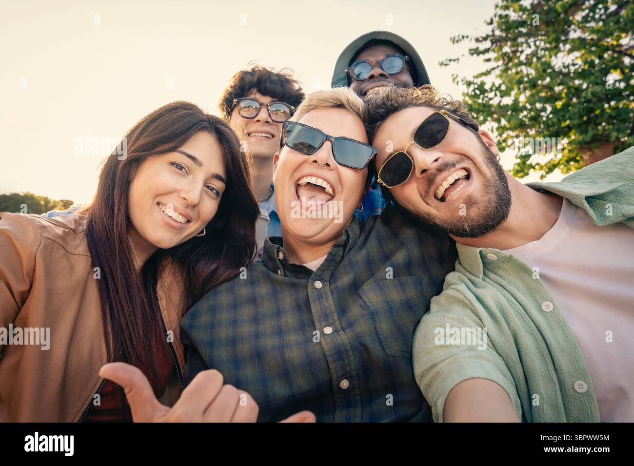 A cheerful and diverse multiethnic group of young adult friends ...