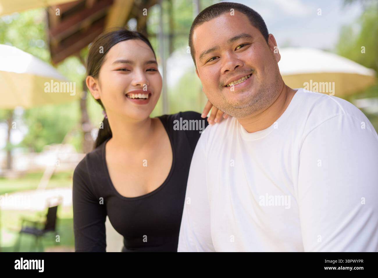 Happy Asian couple smiling in cafe restaurant together Stock Photo - Alamy