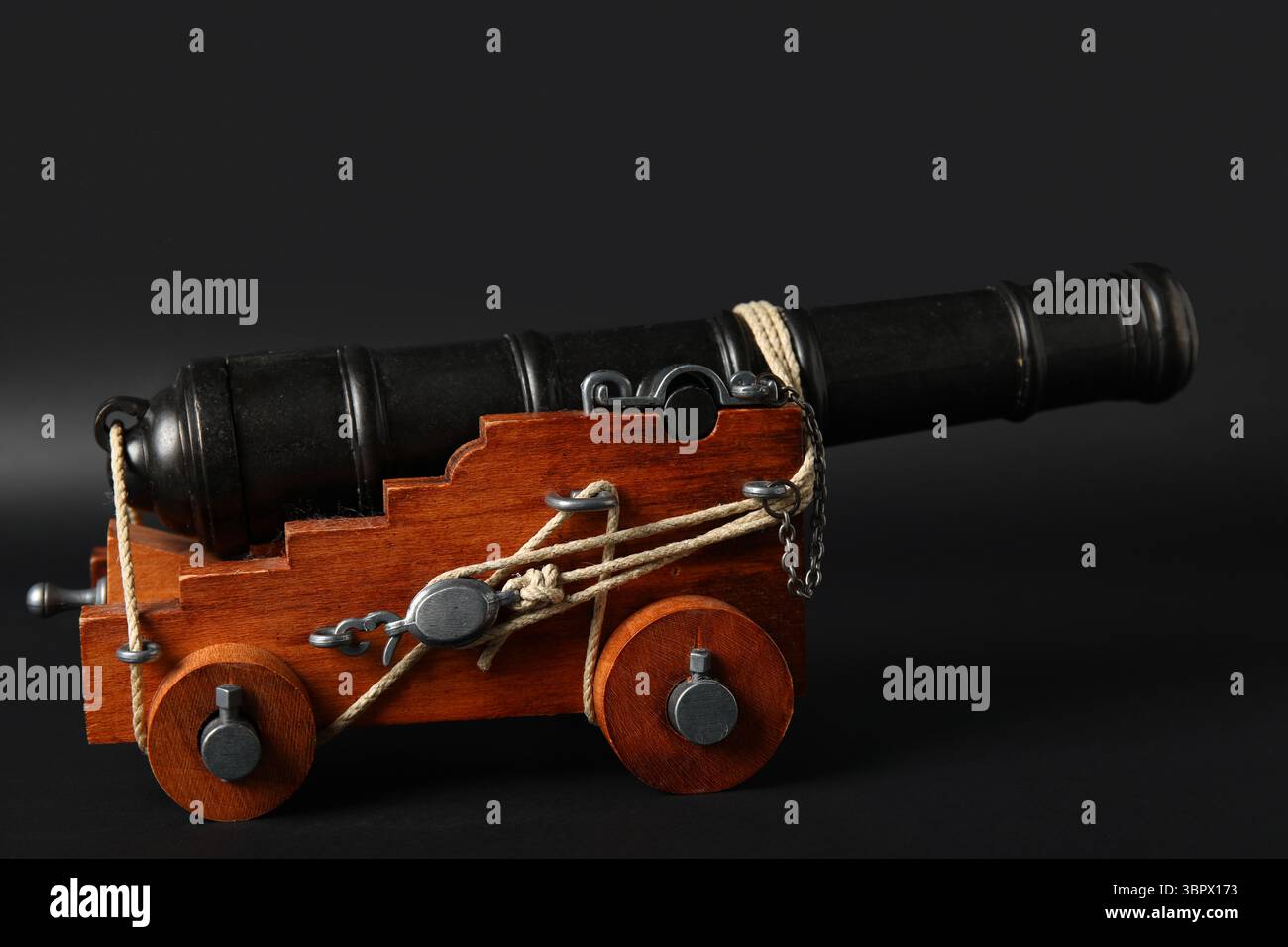Toy model of cannon on black background Stock Photo - Alamy
