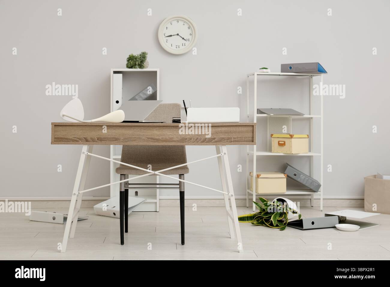 Interior of light office with messy workspace and scattered belongings after earthquake Stock ...