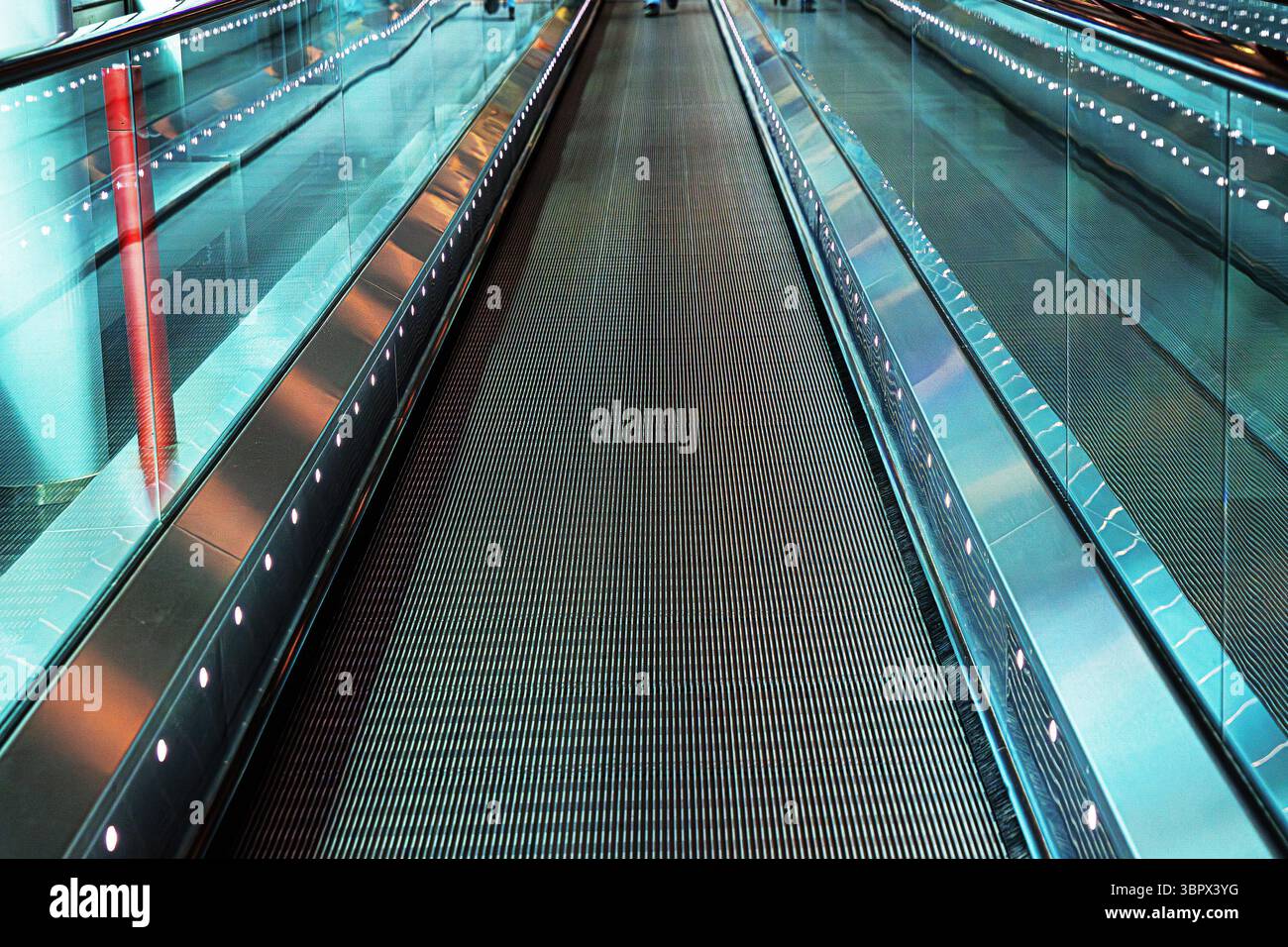 Empty moving walkway in an international airport. Travelator with ...