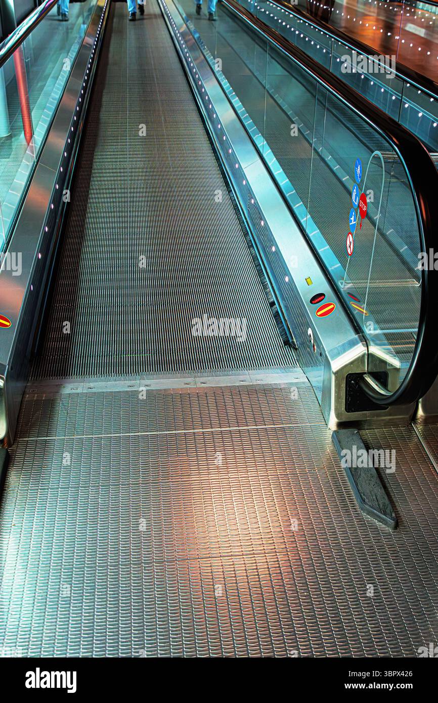 Empty moving walkway in an international airport. Travelator with ...
