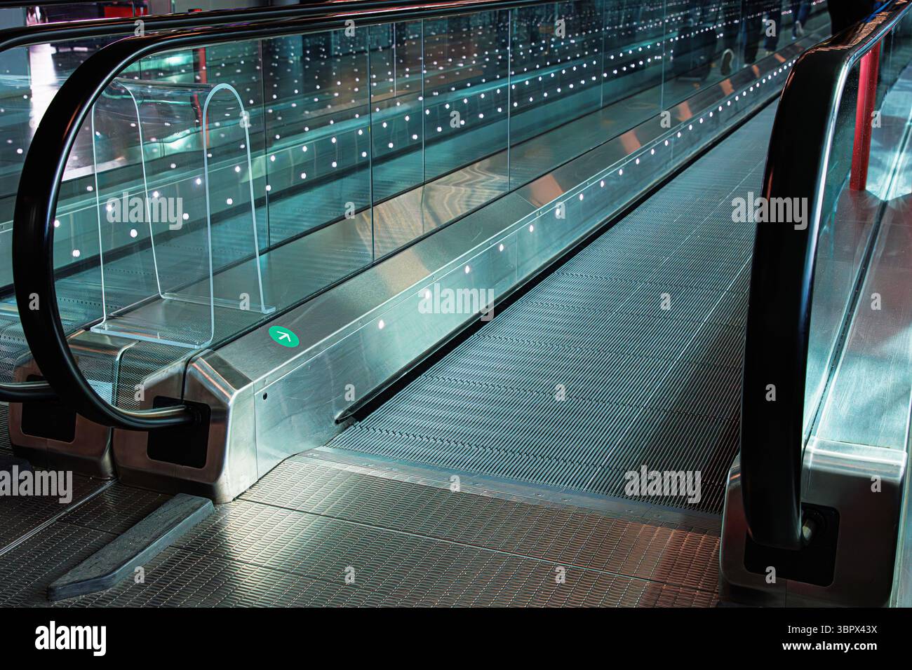 Almost empty moving walkway in an international airport corridor ...