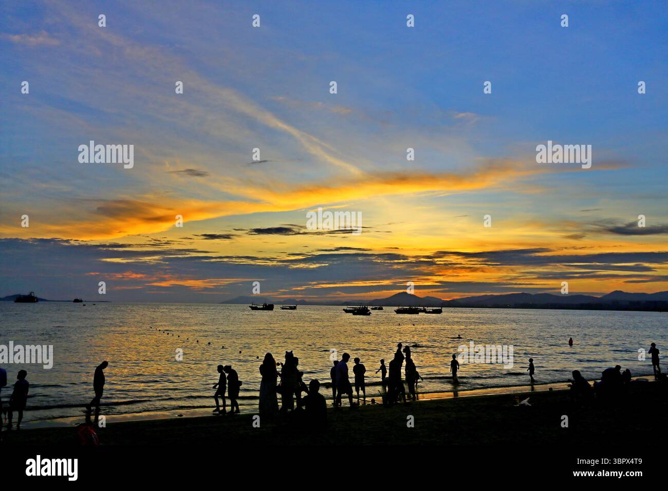 Tourists play at the seaside in Sanya City, southernmost China's Hainan ...