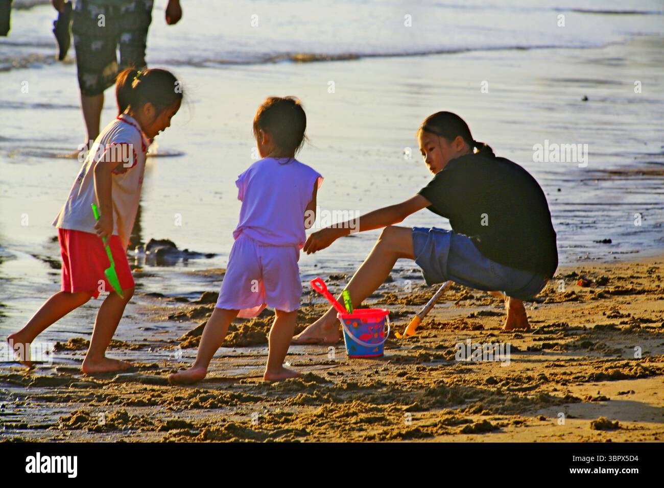 Tourists play at the seaside in Sanya City, southernmost China's Hainan ...
