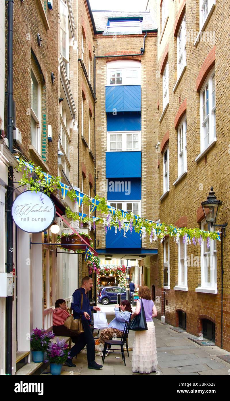 Narrow alley with businesses and a small terrace looking towards Long ...