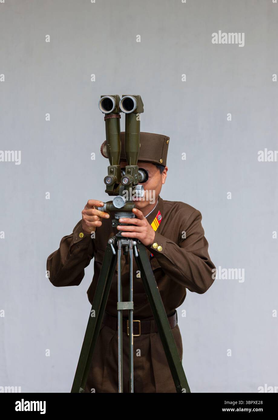 North Korean soldier looking south Korea with binoculars at the DMZ ...