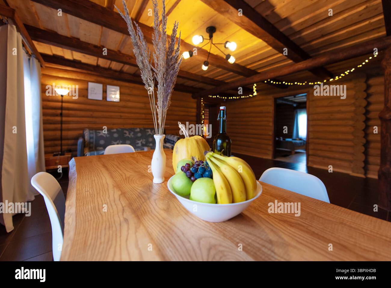 Cozy wooden cabin interior with a dining table featuring a fruit bowl ...