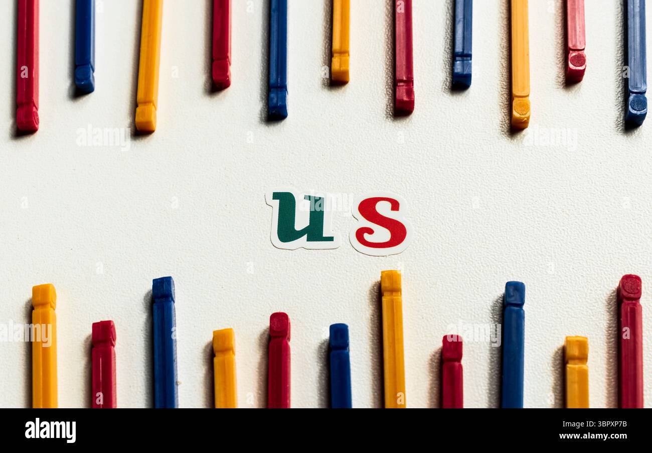 Colorful sticker word 'US' surrounded by vibrant plastic sticks on ...
