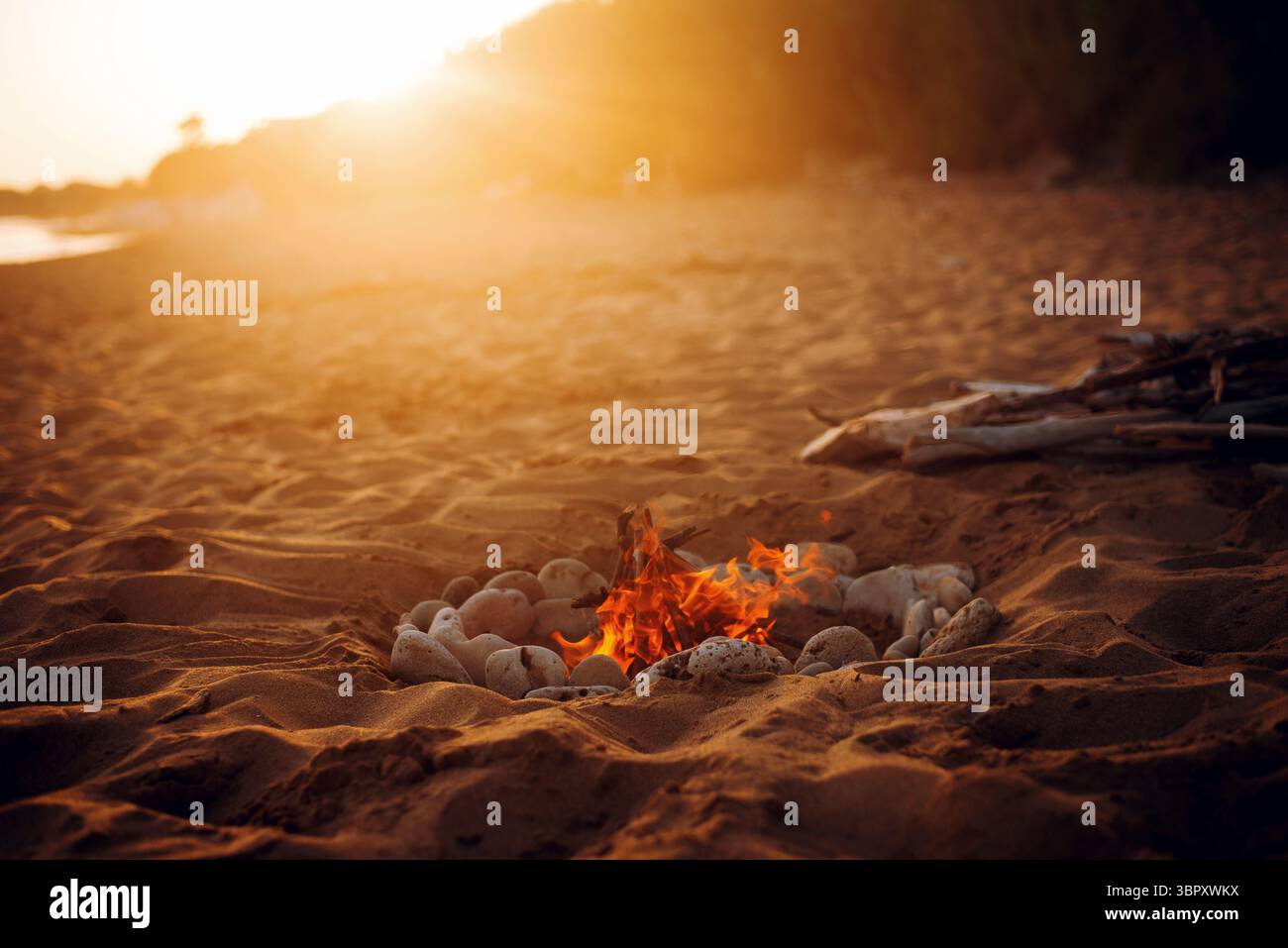 Campfire on a beach during sunset. Beautiful nature. Gathering of ...